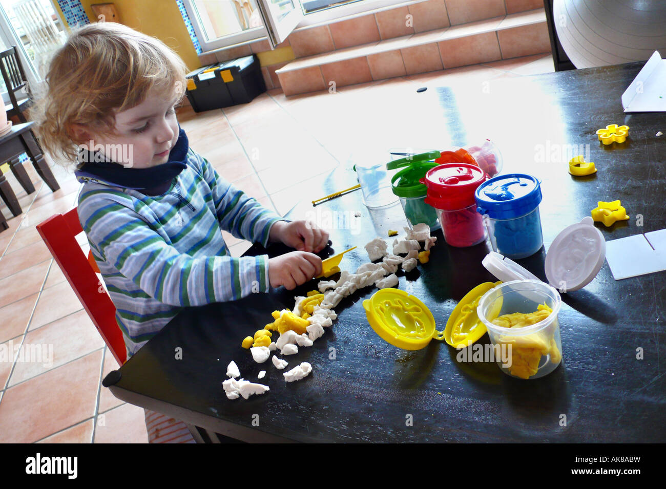 small boy playing with modeling clay Stock Photo - Alamy