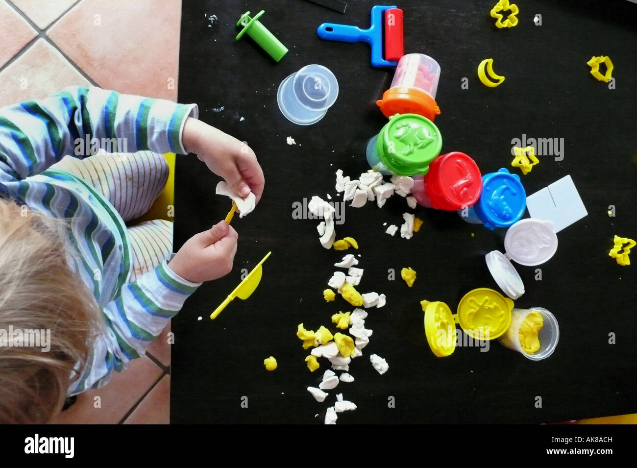 small boy playing with modeling clay Stock Photo - Alamy
