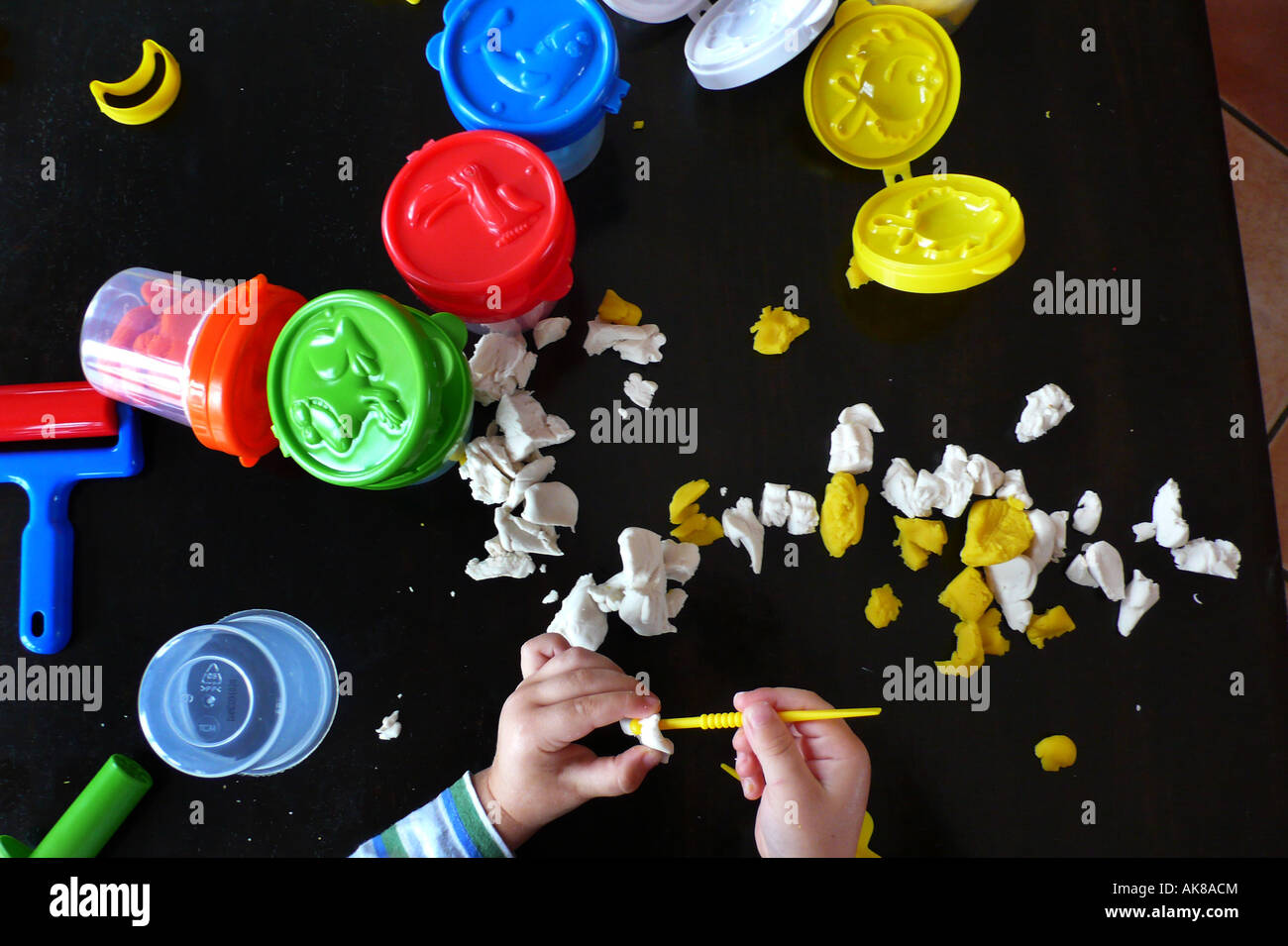 small boy playing with modeling clay Stock Photo - Alamy