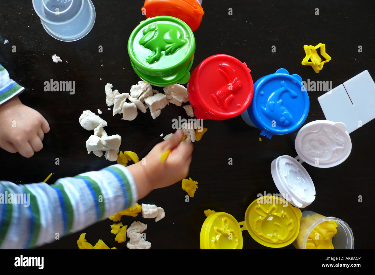 small boy playing with modeling clay Stock Photo - Alamy