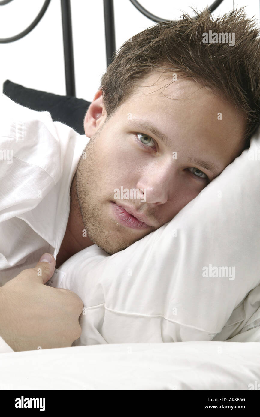tired young man looking at camera Stock Photo - Alamy
