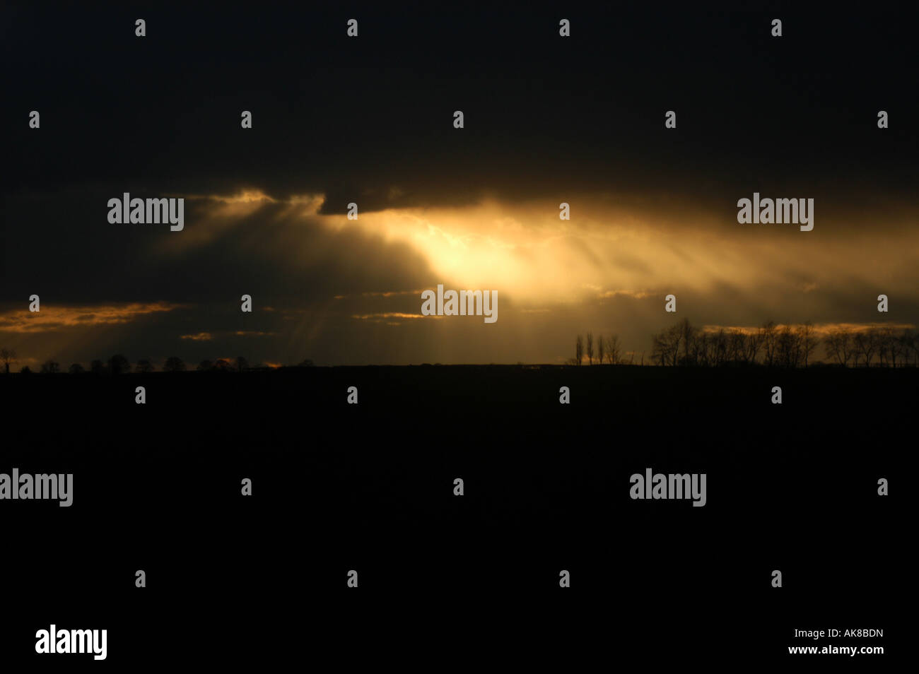 Sunlight breaking through dark clouds Stock Photo - Alamy