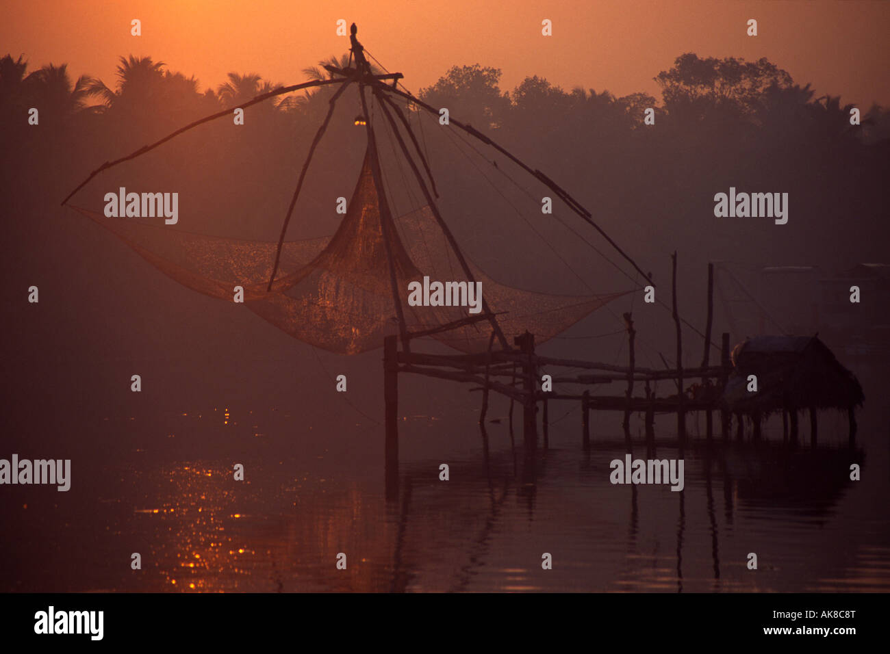A Chinese-fishing net during sunset Stock Photo - Alamy