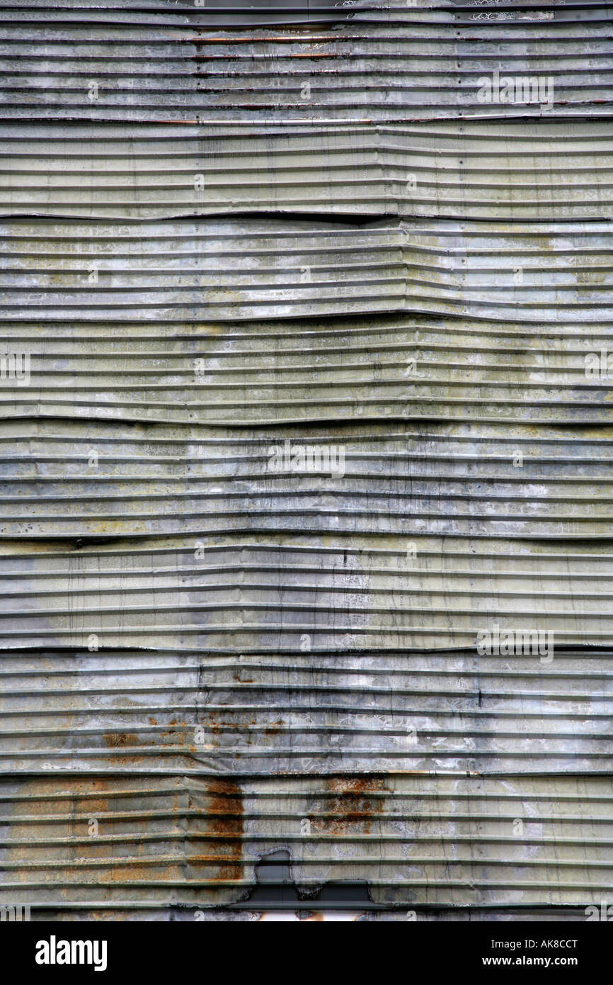 Detail of fire-damaged cladding to disused and burnt-out factory ...