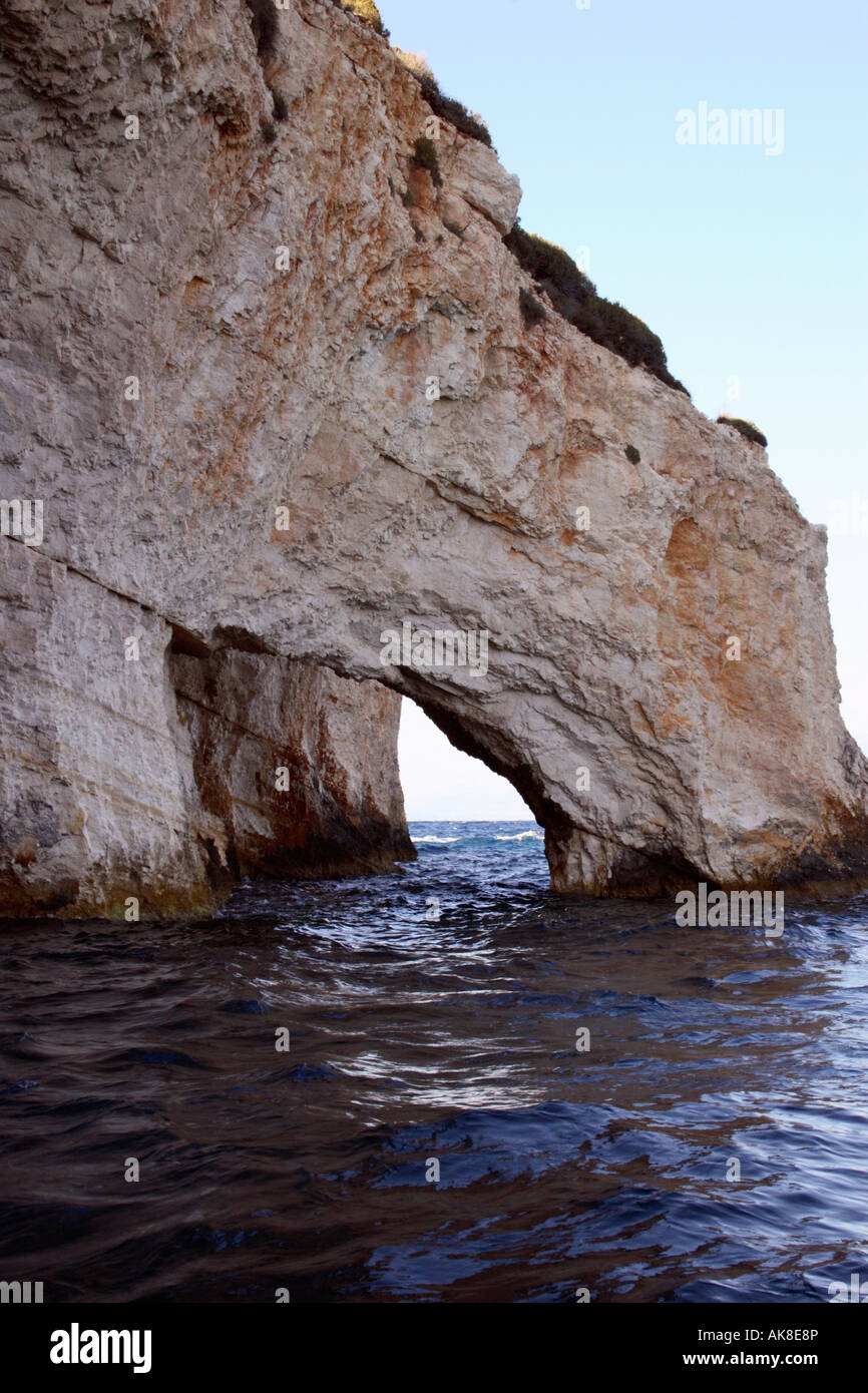 A natural arch in the cliffs at Blue Water Caves, Zakynthos, Greece ...