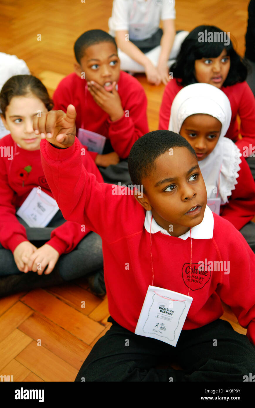 Primary school pupils asking questions during a healthy eating day ...