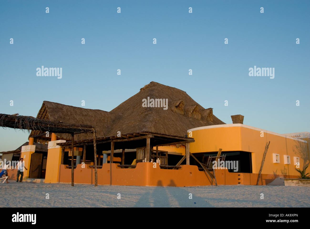 Orange Beachfront Hotel with Thatched Straw Roof and White Sandy Beach ...