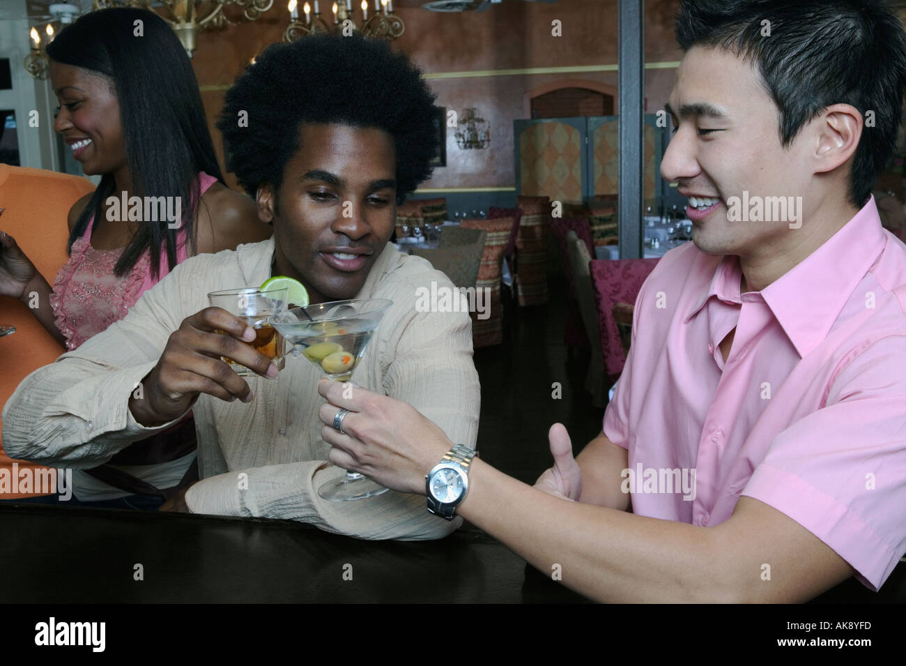 Young men toasting each other Stock Photo - Alamy