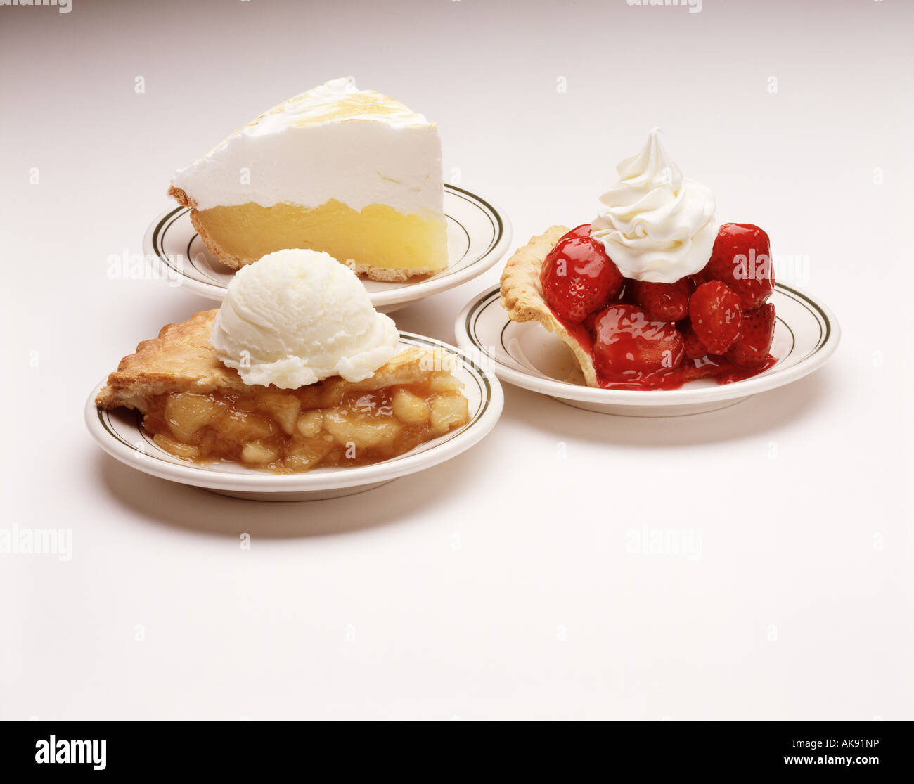 three desserts lemon meringue strawberry apple pie ala mode vanilla ice ...