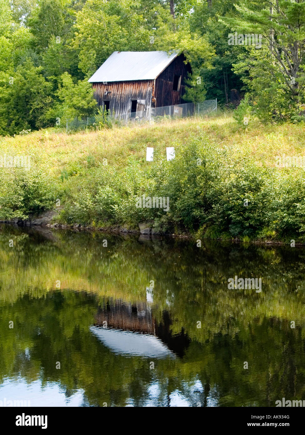 The slide masters cabin reflected in the Coulonge River at the Chutes ...