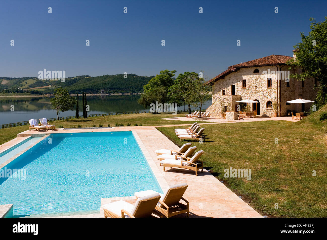 Rectangular swimming pool and traditional Italian country house beside ...