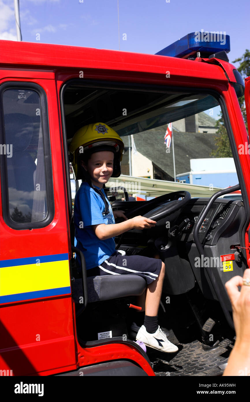 fire engine child helmet at wheel playing being at fireman driving ...