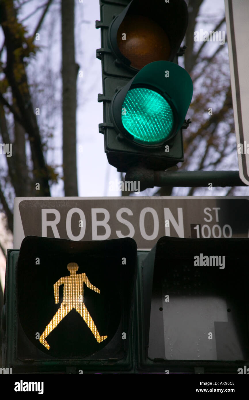 Robson Street green traffic control light and pedestrian walk sign ...
