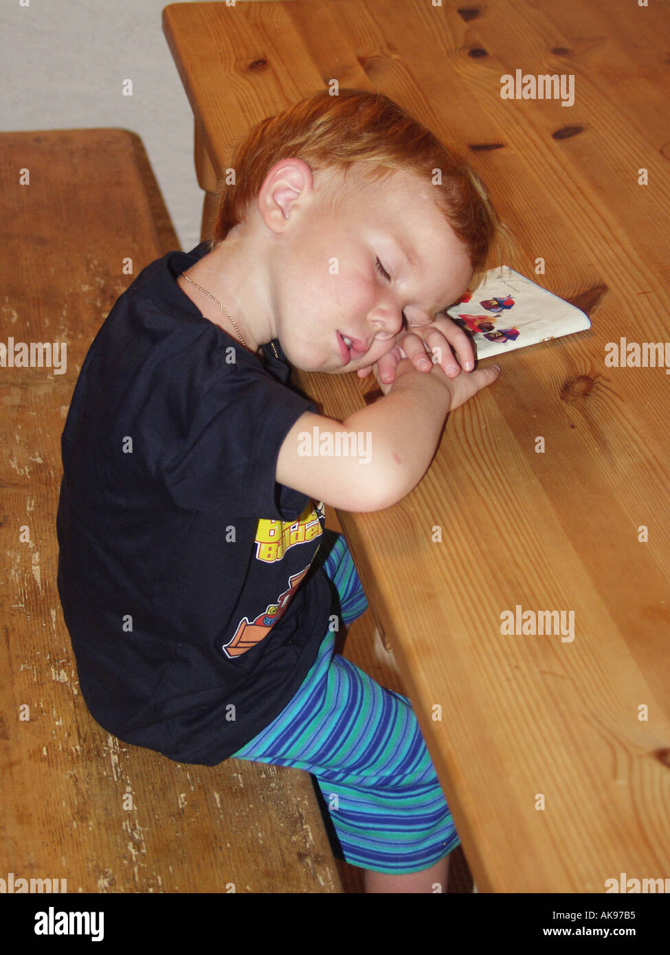 little boy is sleeping at the table MR Stock Photo - Alamy