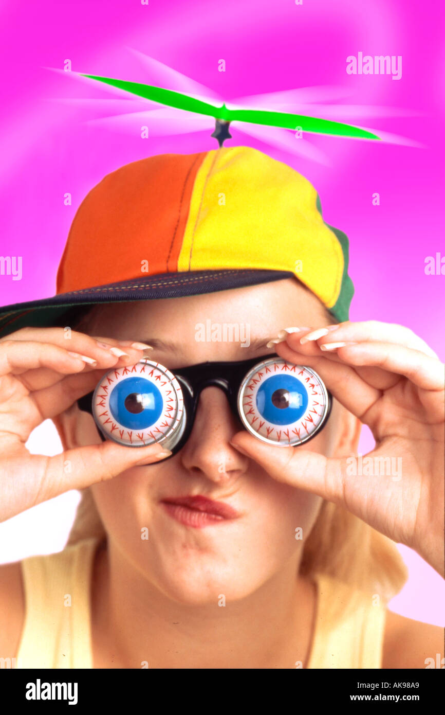Teenage girl making funny face with fake google eyes eyeballs Stock ...