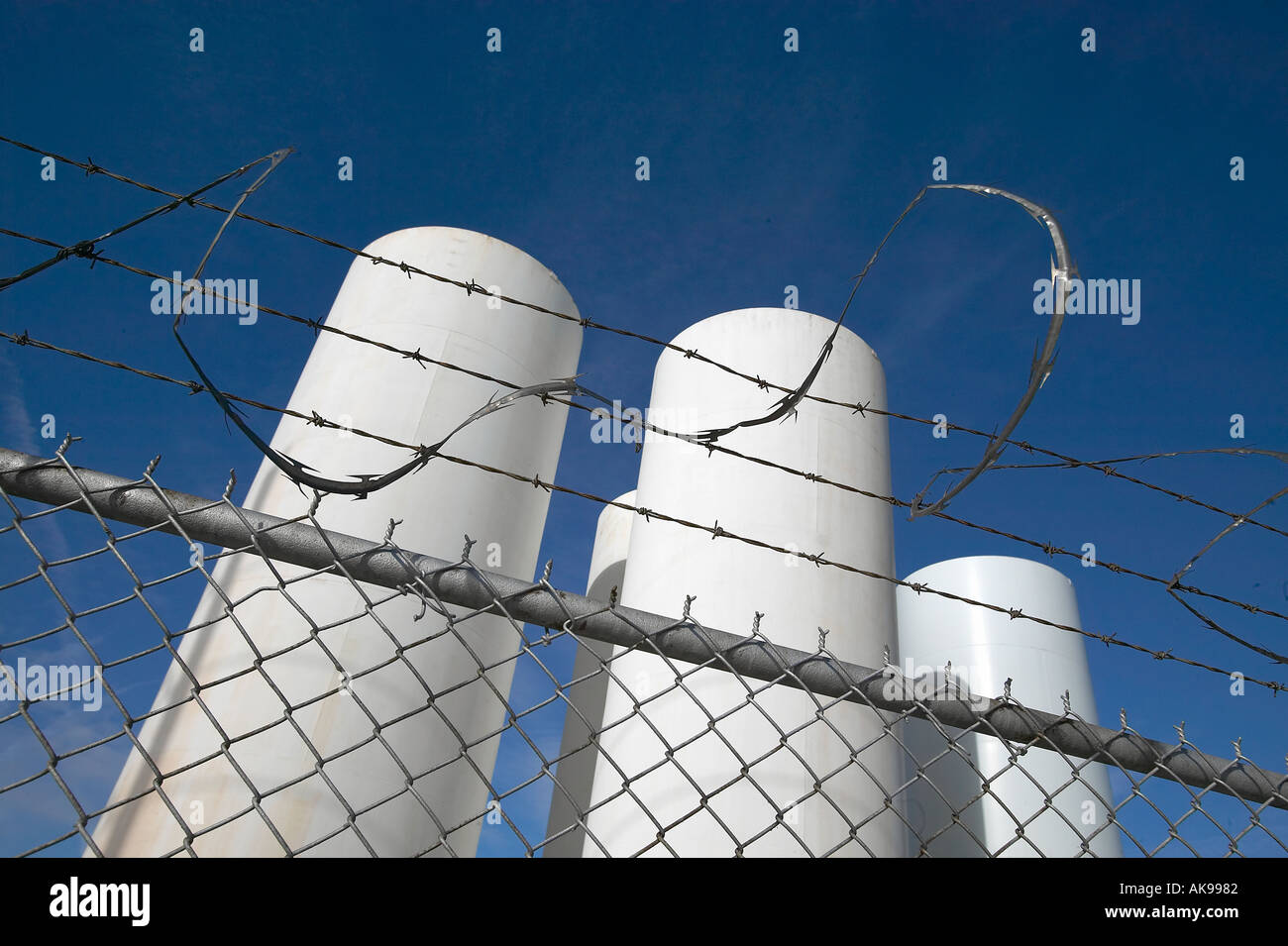 Chemical Tanks behind Barbed Wire Stock Photo - Alamy
