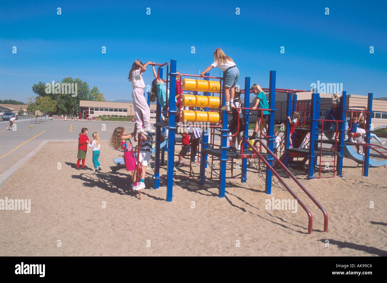 Elementary school students climbing on playground toys Stock Photo - Alamy