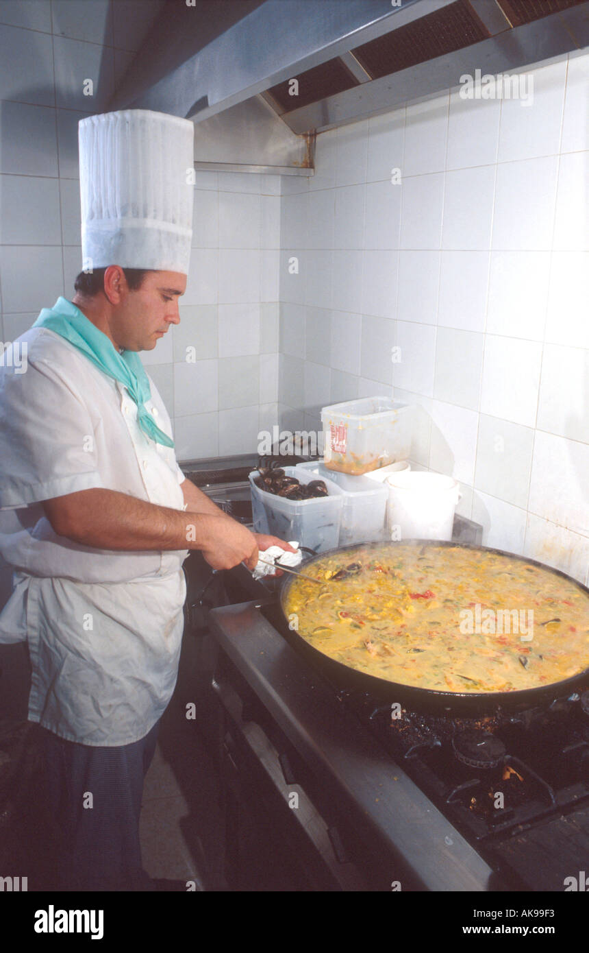 Spanish chef making paella rice and fish dish Stock Photo - Alamy