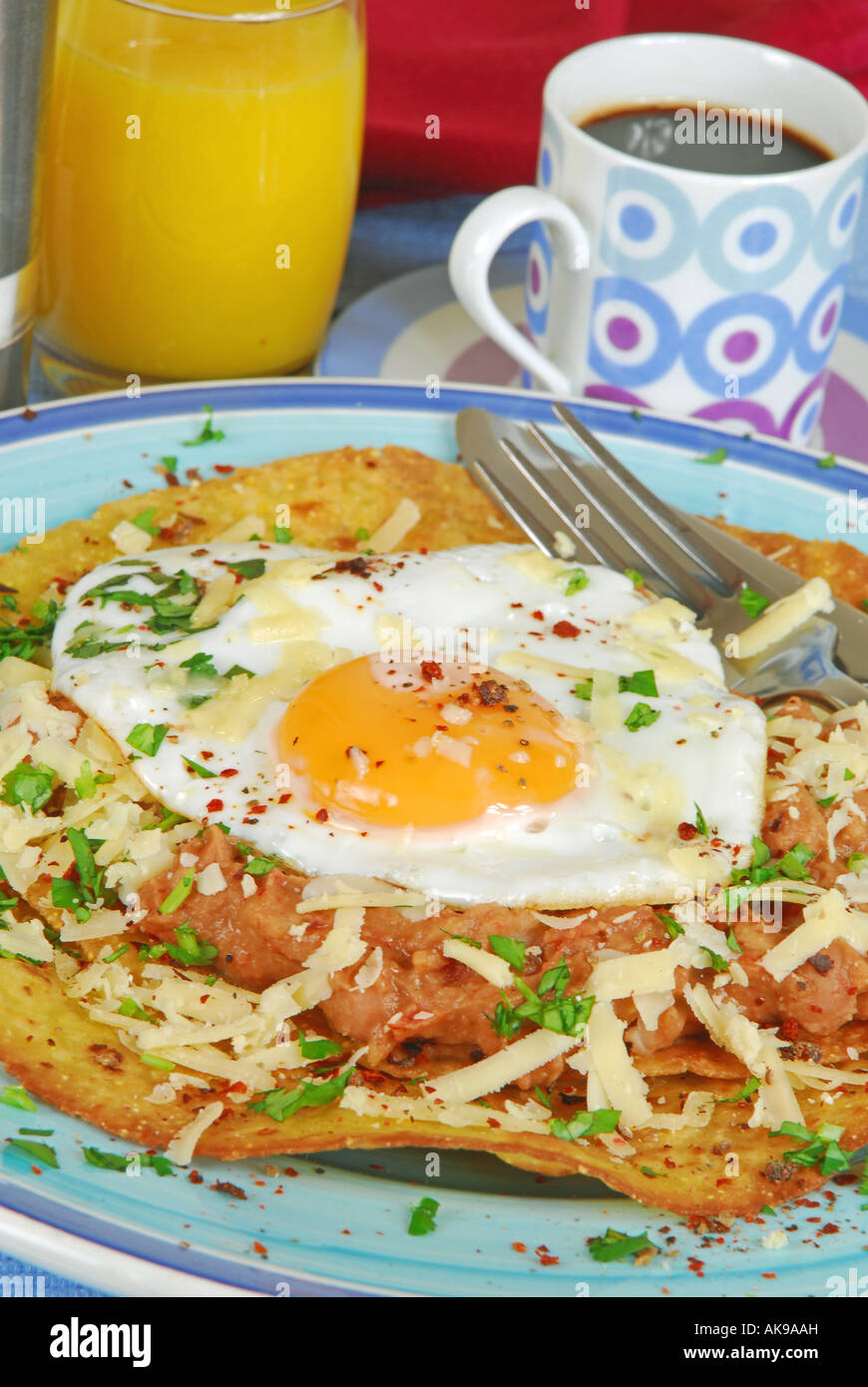 A Mexican-style breakfast of huevos rancheros: a fried corn tortilla ...