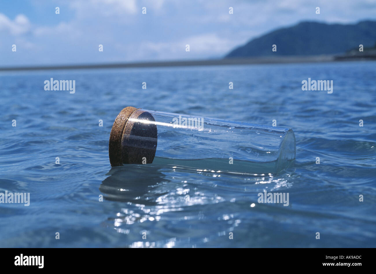 Bottle floating on the wave Stock Photo - Alamy