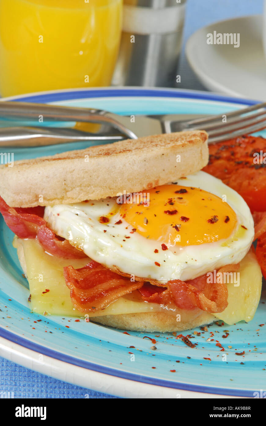 A breakfast of grilled back bacon rashers, cheddar cheese and fried egg ...