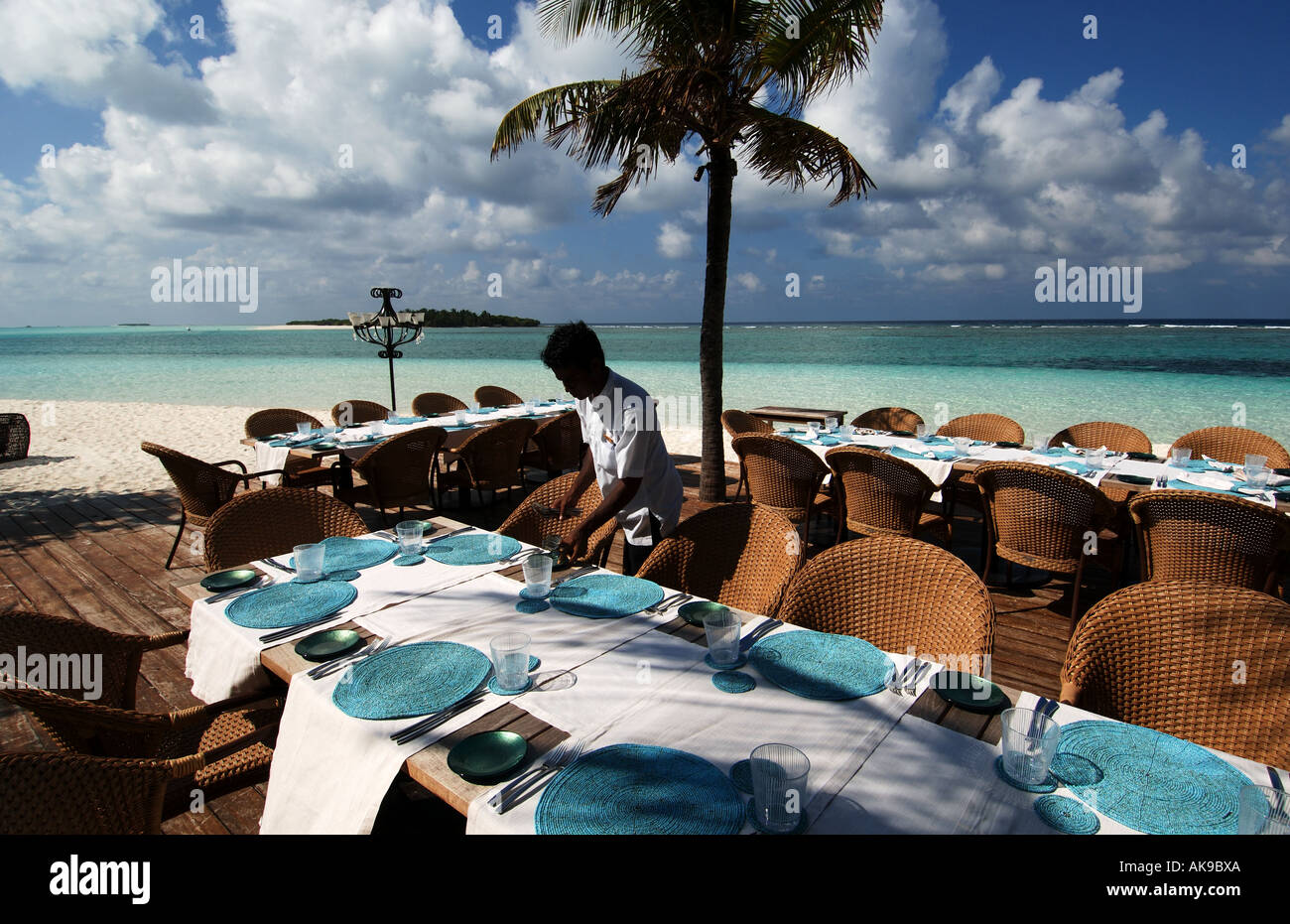 Maldives waiter is laying the table Stock Photo - Alamy