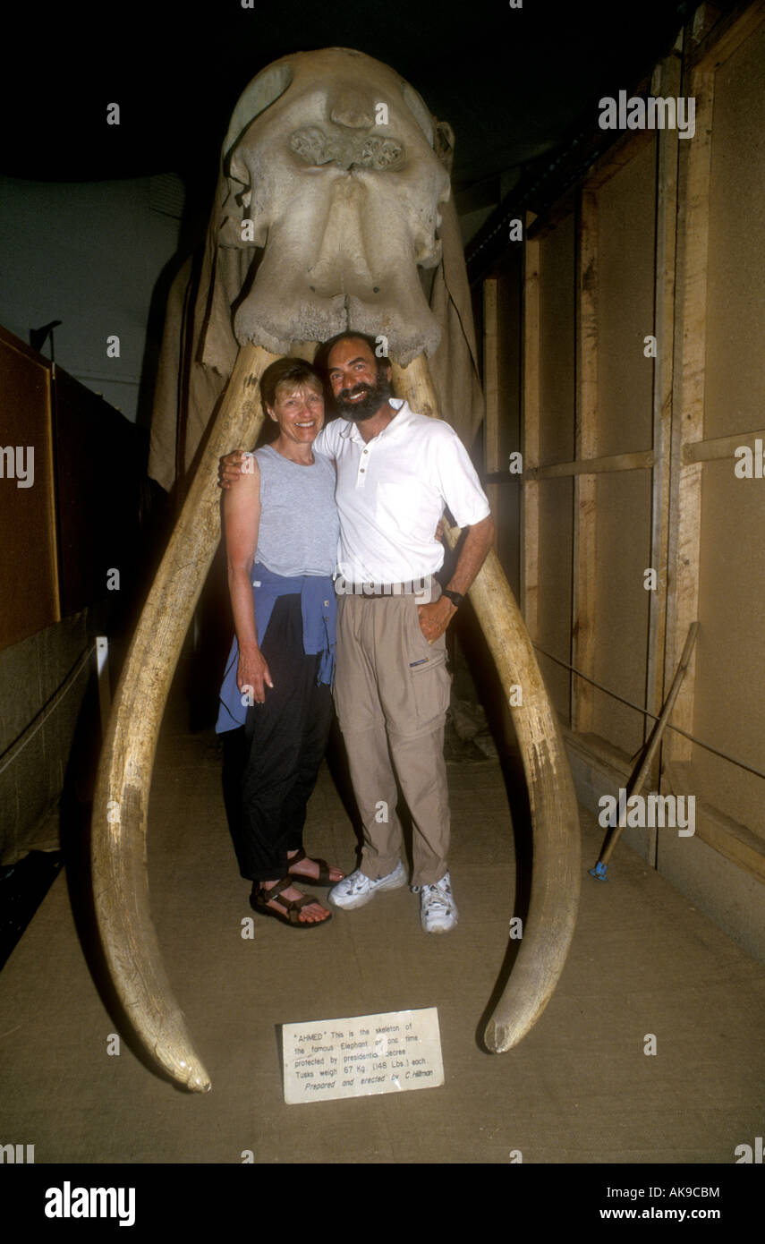 A white couple poses between the perfect tusks of Ahmed a famous ...