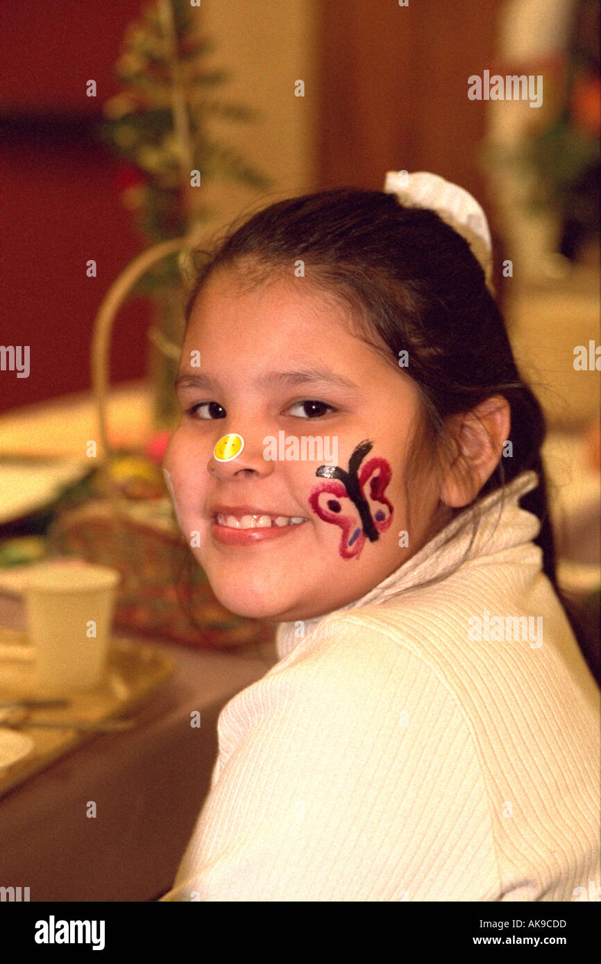 American Indian girl age 12 smiling with butterfly face paint at ...