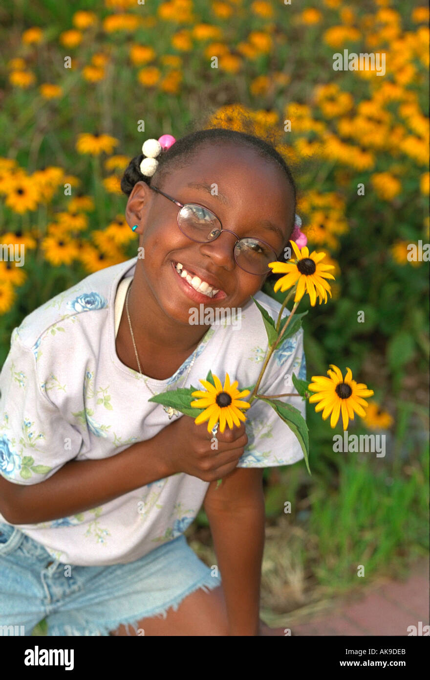 Black girl age 10 with daisies at Youth Express 10th anniversary picnic ...