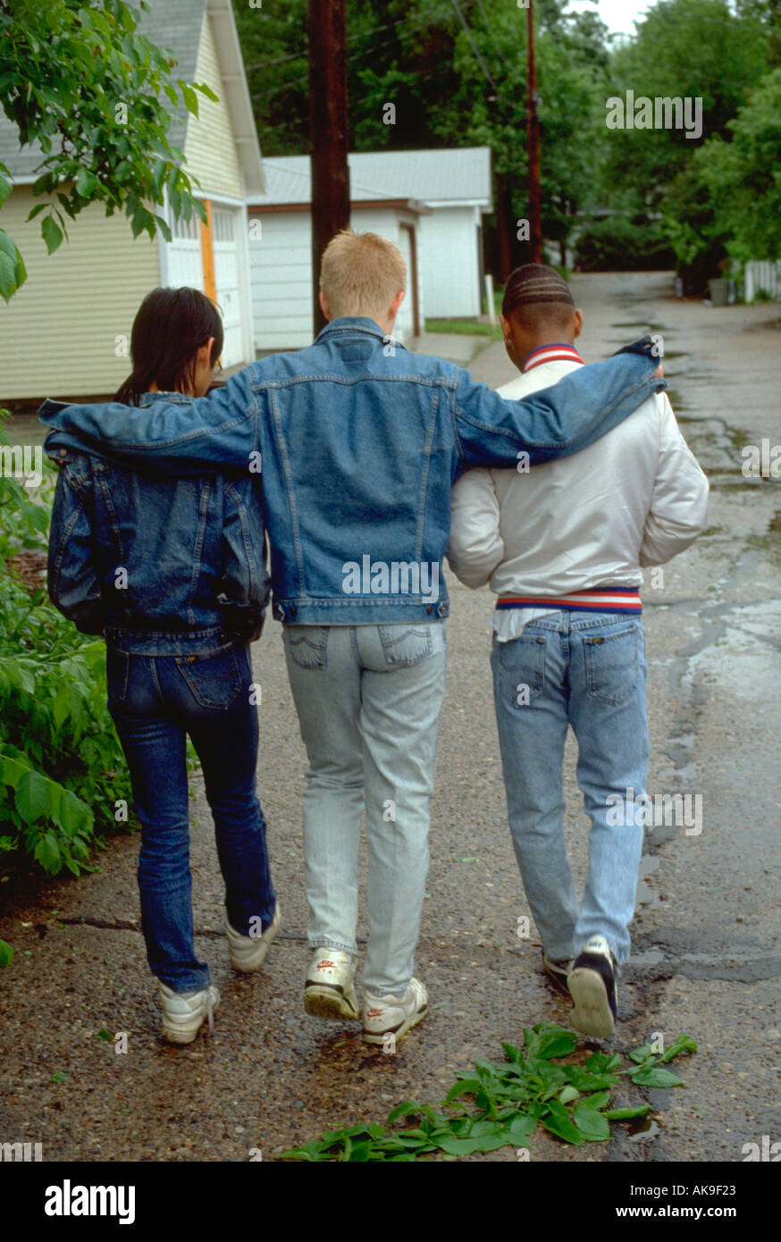 Three friends walking arms around hi-res stock photography and images ...