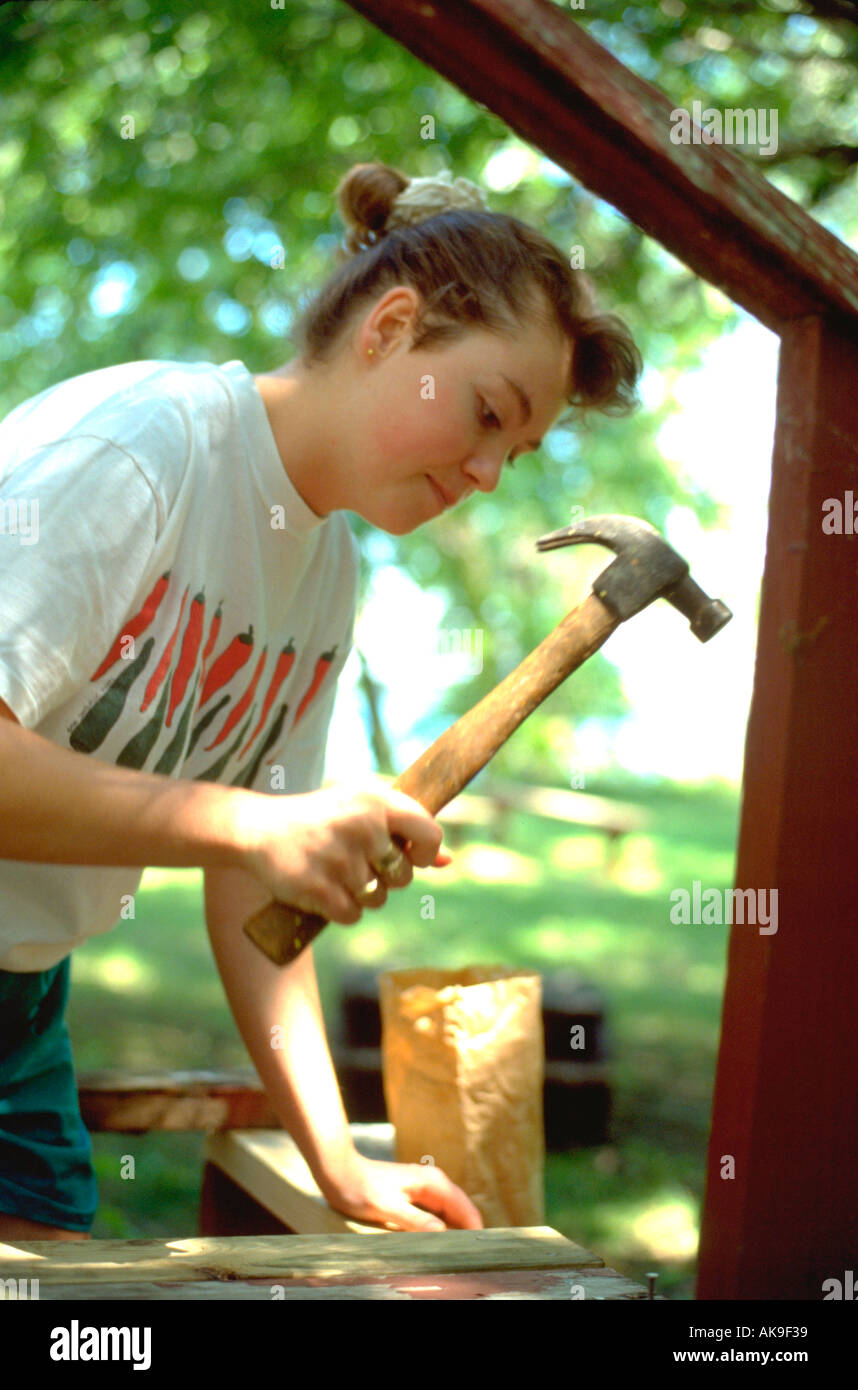 20 year old woman repairing step at lake cabin. Clitherall Minnesota ...