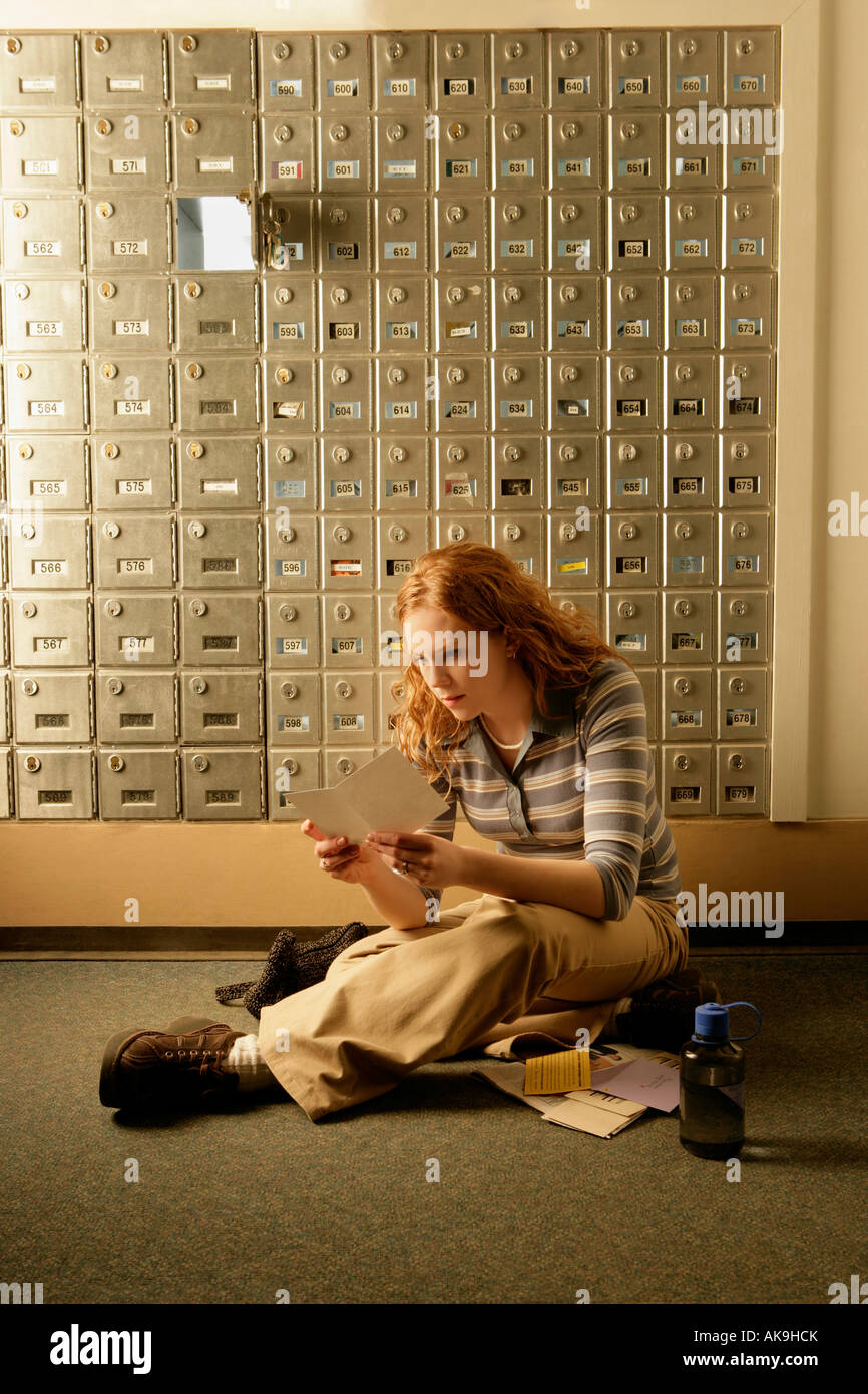 Lady opening mail at post office boxes Stock Photo - Alamy
