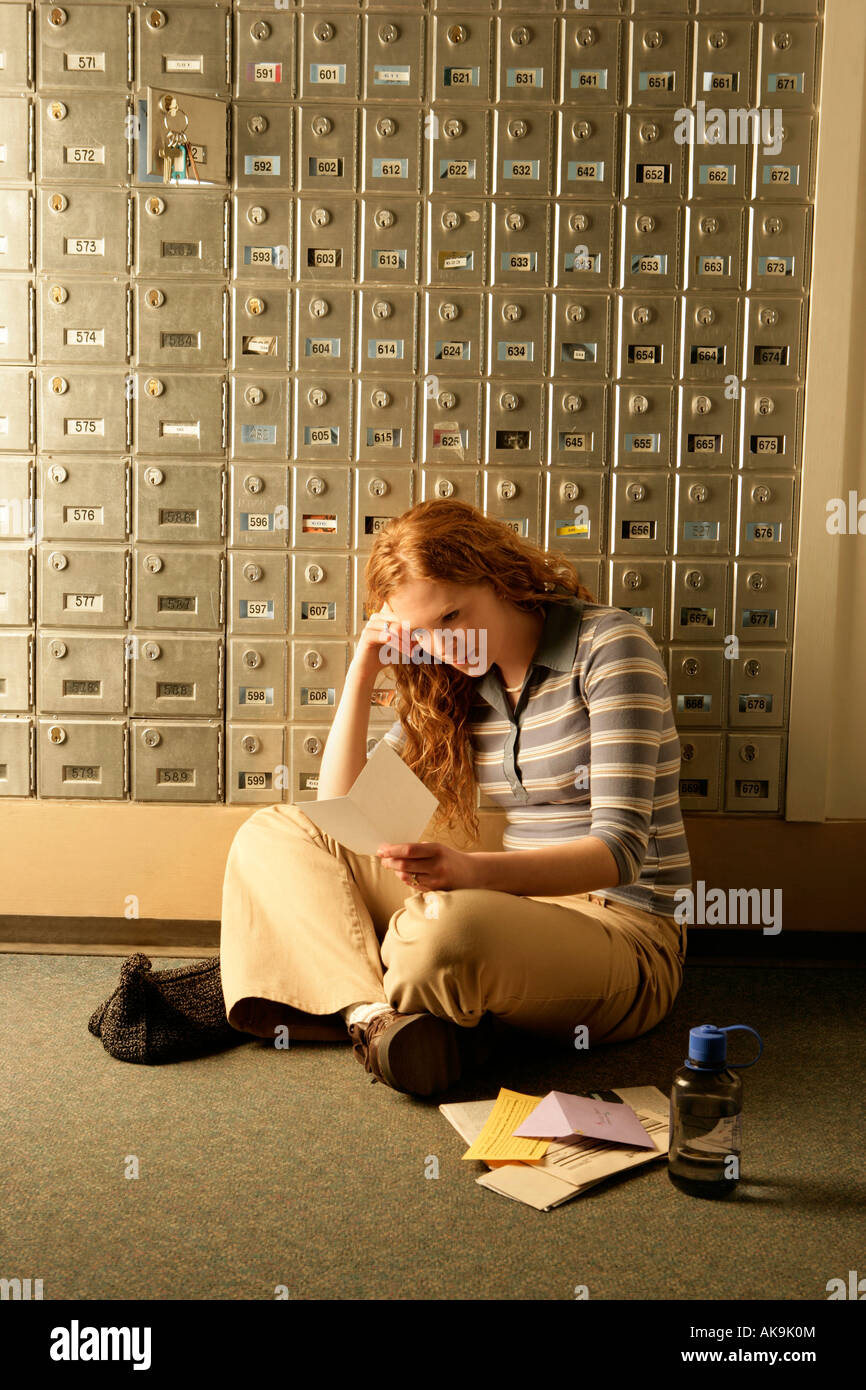 Lady opening mail at mailboxes Stock Photo - Alamy