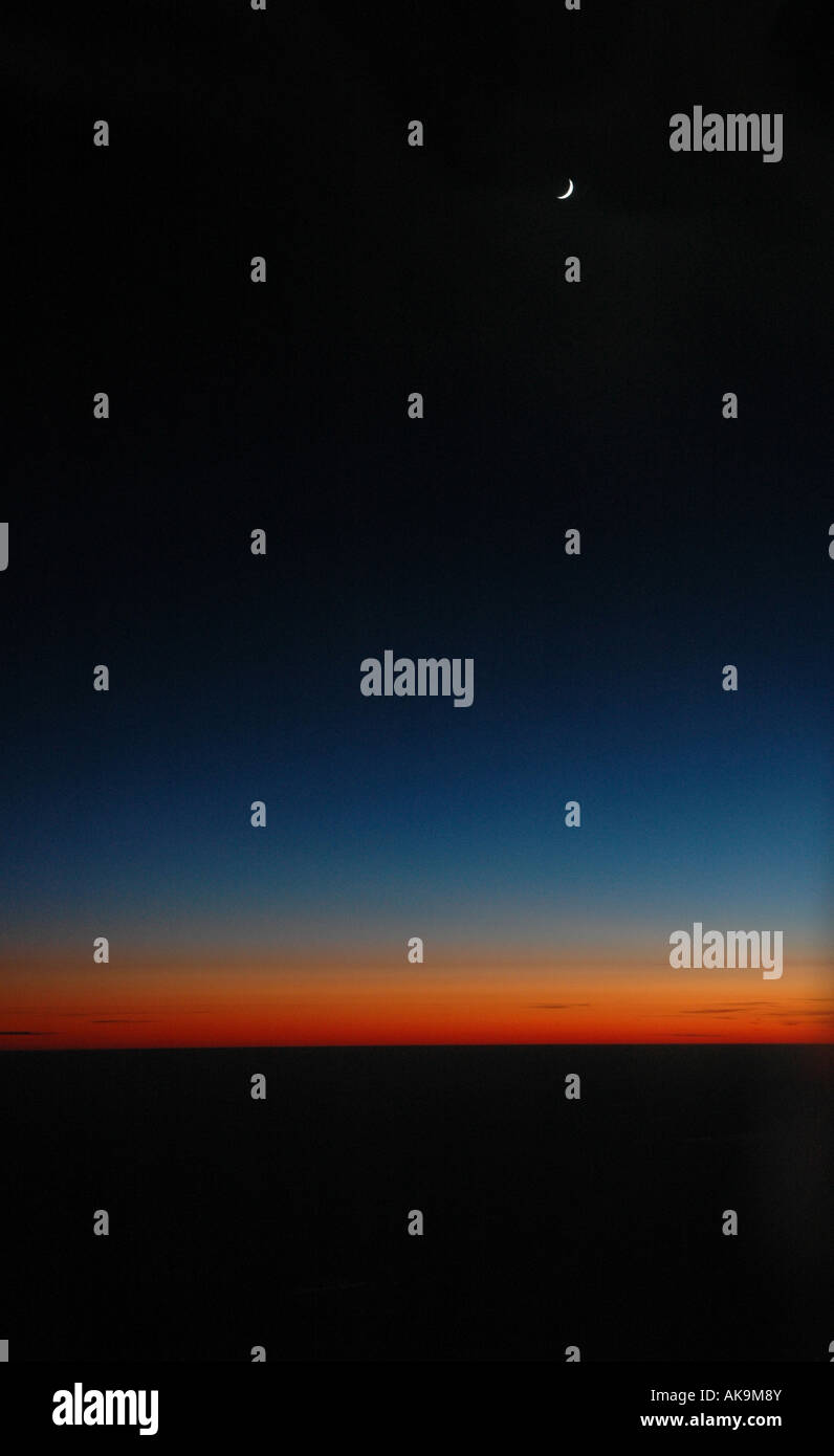 Aerial photo of Sunrise from aircraft with moon in upper frame Stock ...