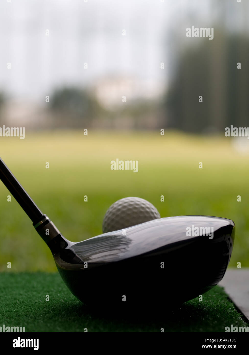 Golf club with ball at driving range Stock Photo - Alamy