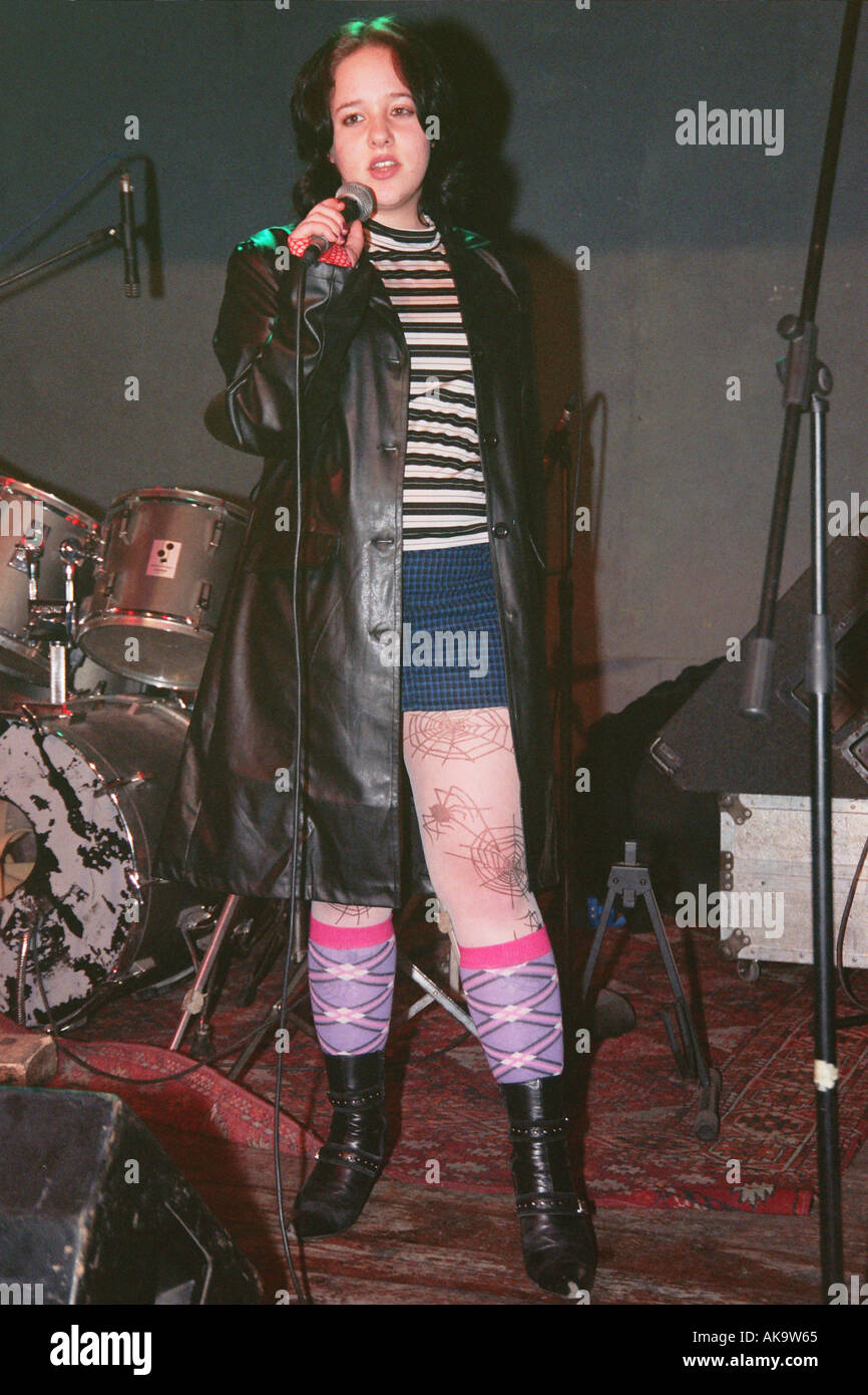 A young female singer with a leather coat on stage Stock Photo - Alamy