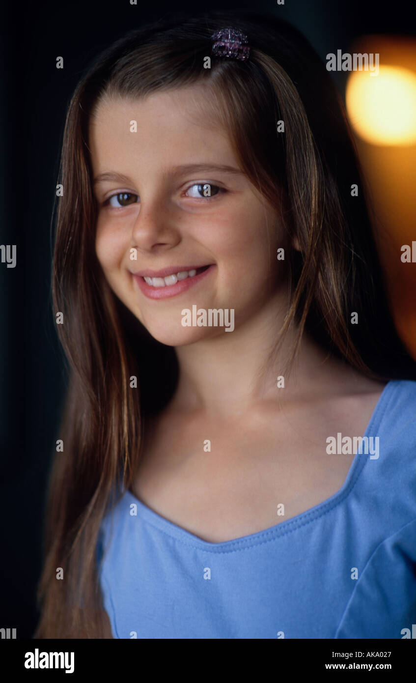 portrait of an eight years old girl smiling at the camera with ...