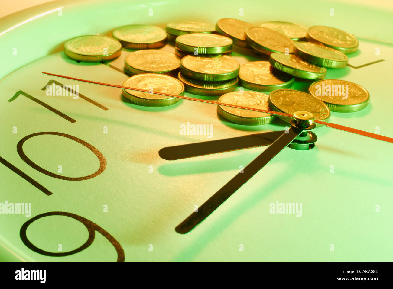 Coins on Clock Stock Photo - Alamy