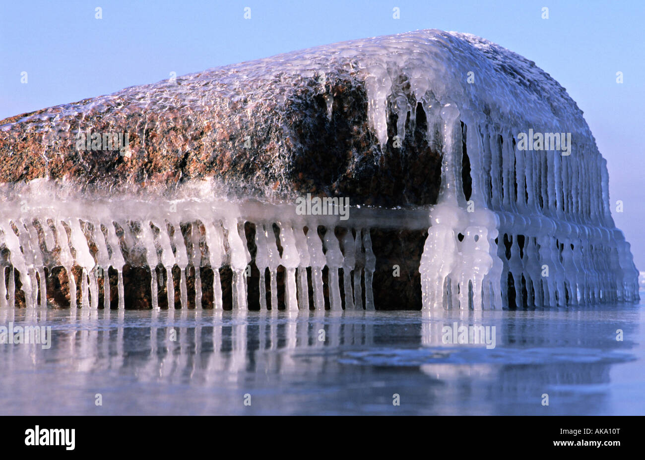 Ice covered boulder at seaside Stock Photo - Alamy
