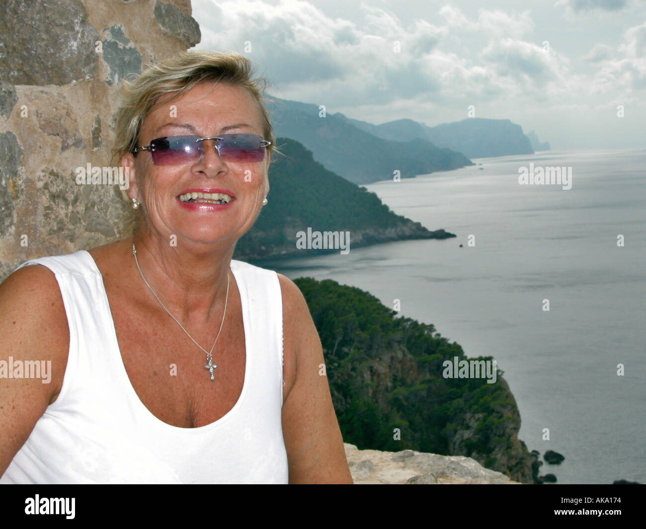 Rene 56 years old smiling towards camera Background is a beautiful view ...