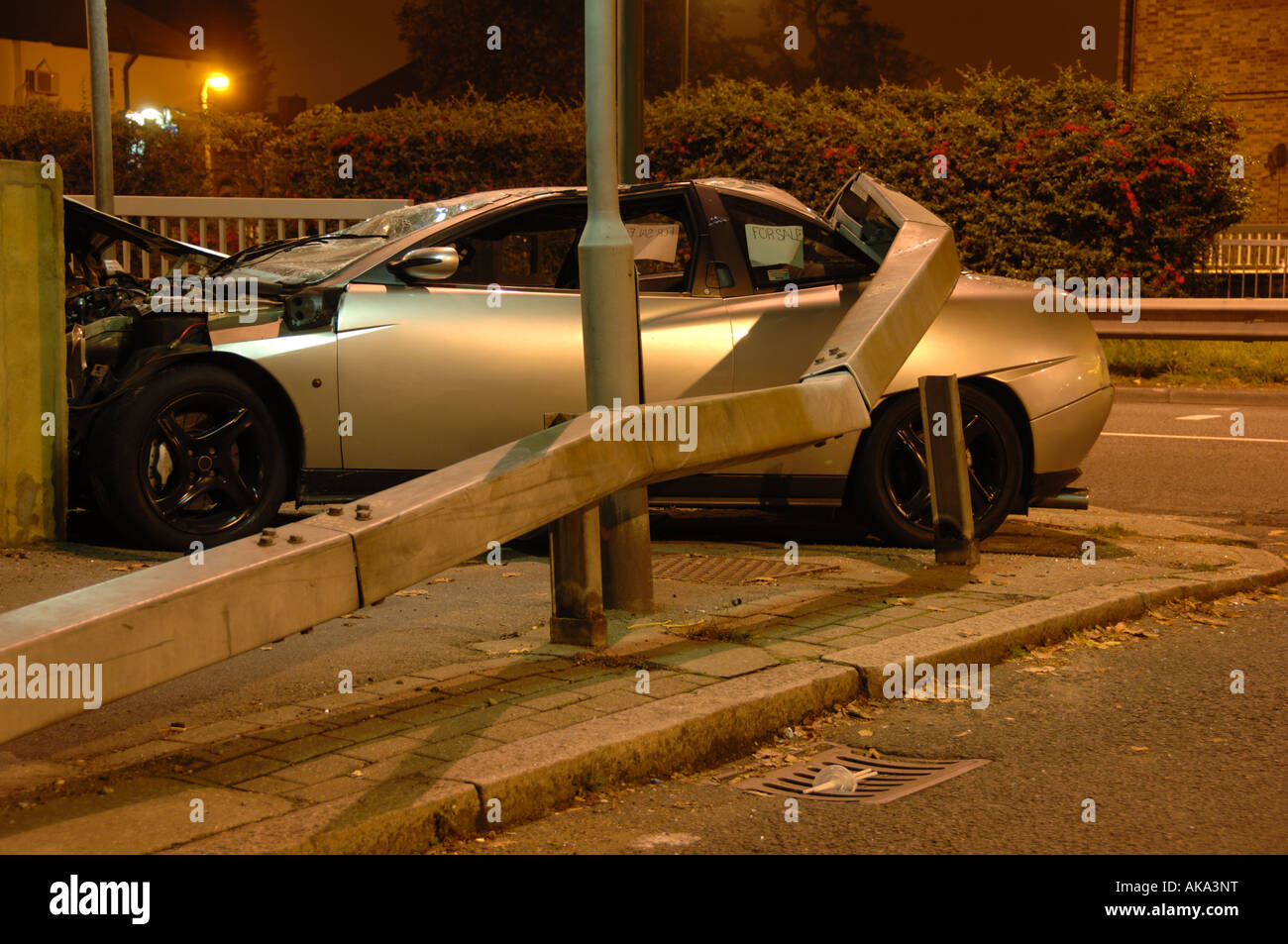 Car crashed under barrier at night Stock Photo - Alamy