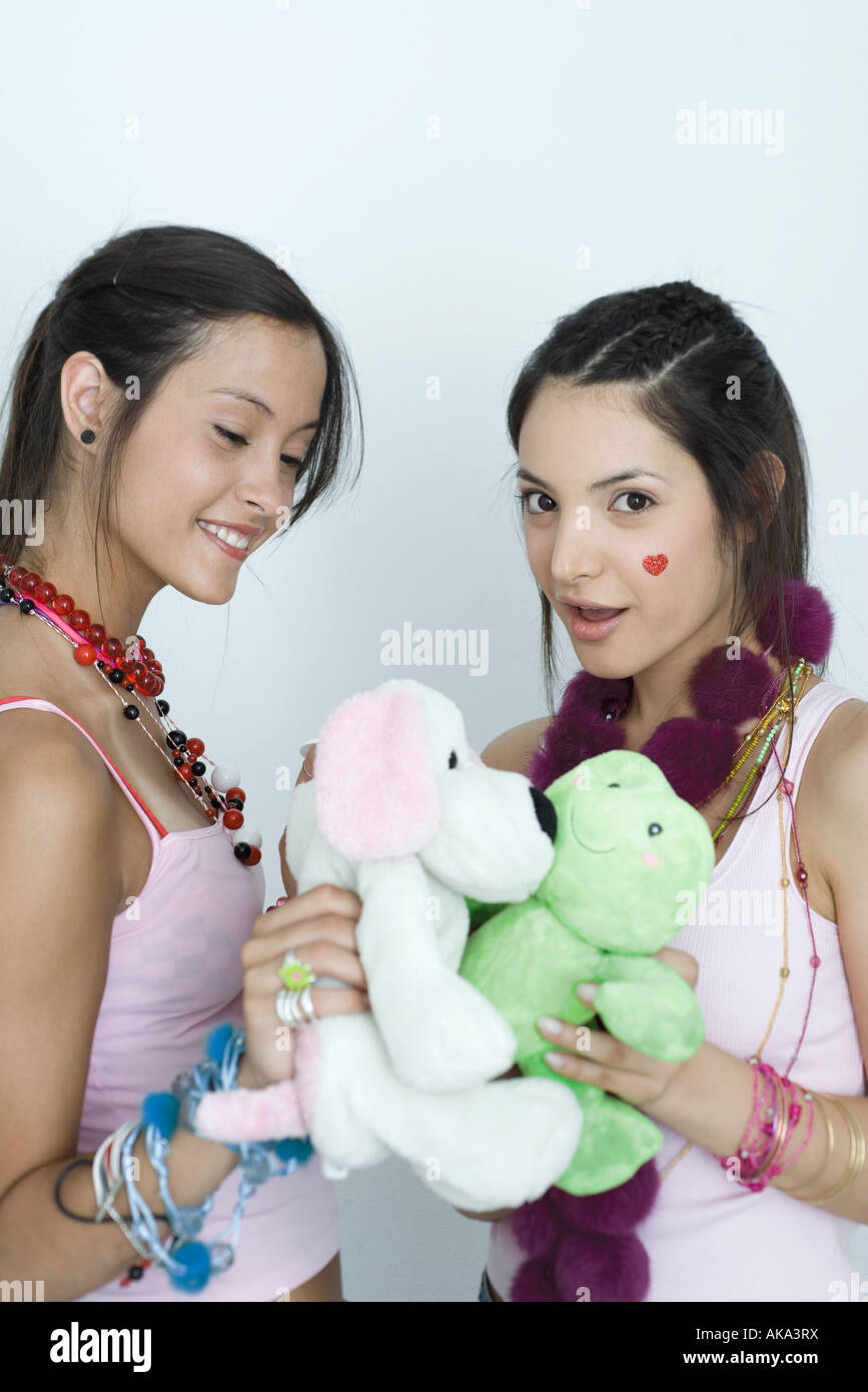 Two young female friends with stuffed animals, portrait Stock Photo - Alamy