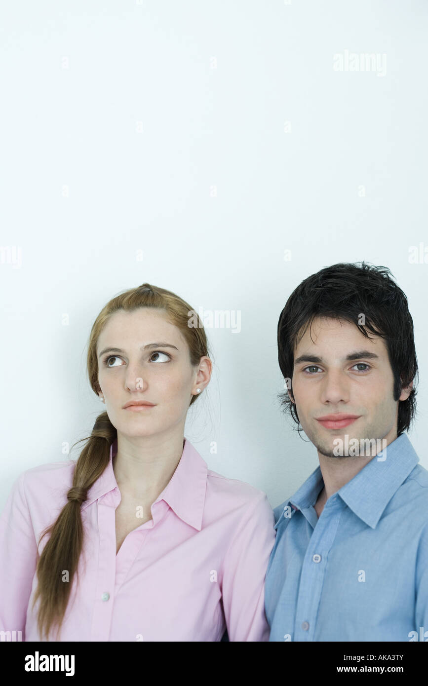 Young couple, man looking at camera while woman looks away, portrait ...