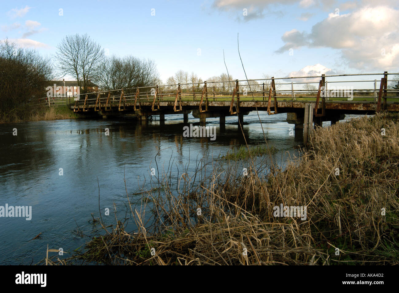 Rural bridge over river and Flooded field Stock Photo - Alamy