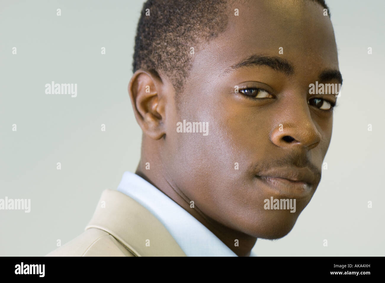 Young male looking at camera, sideways glance, portrait Stock Photo - Alamy
