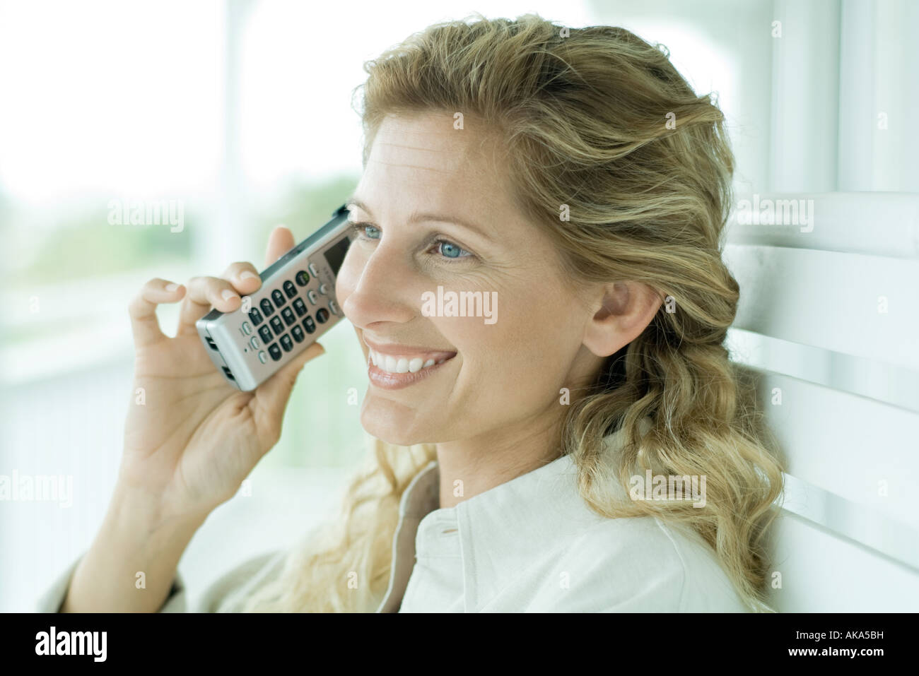 Woman casually sits outside using hi-res stock photography and images ...