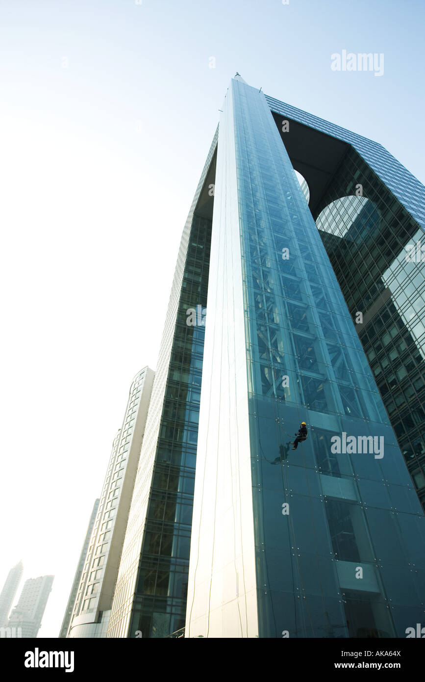 Window washer on side of skyscraper, low angle view Stock Photo - Alamy