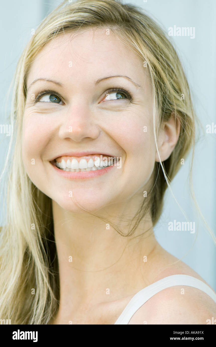 Young woman smiling, looking up, portrait Stock Photo - Alamy