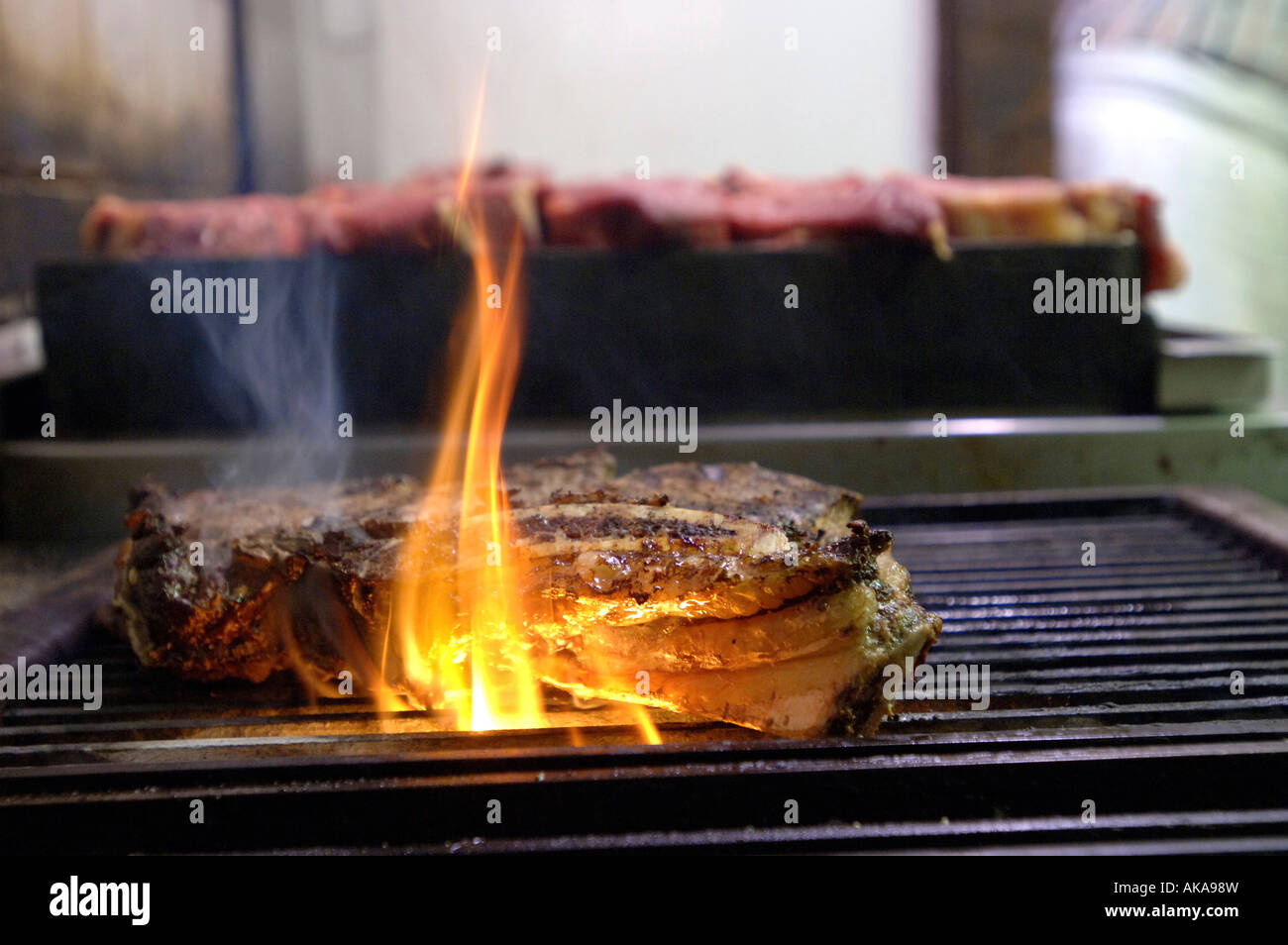 Grilling steak on the bbq Stock Photo - Alamy