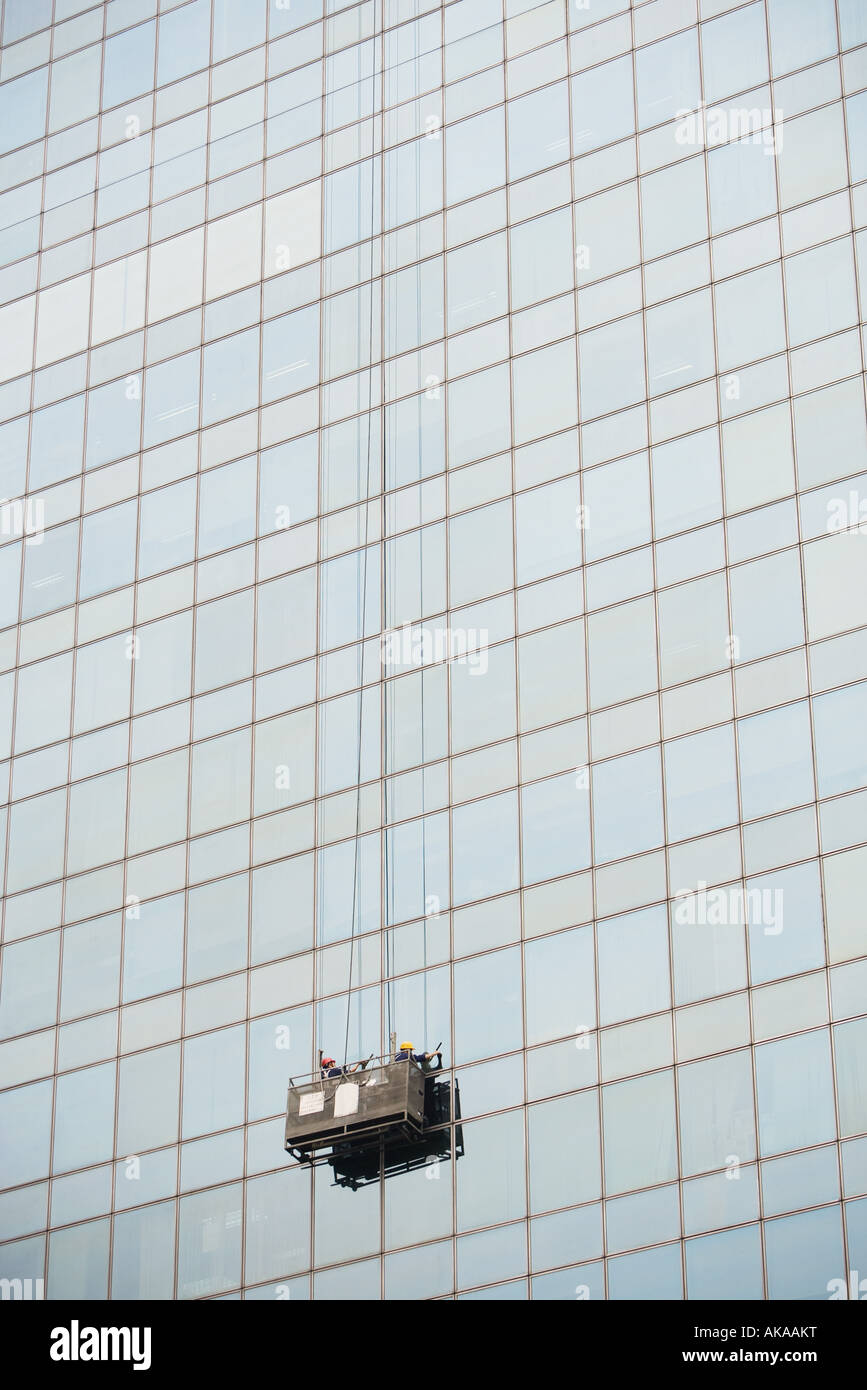 Window washers cleaning side of skyscraper Stock Photo - Alamy